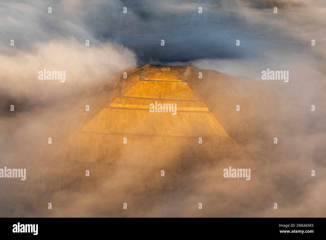 From above of pyramid slope covered by thick gray mist during tourist ...