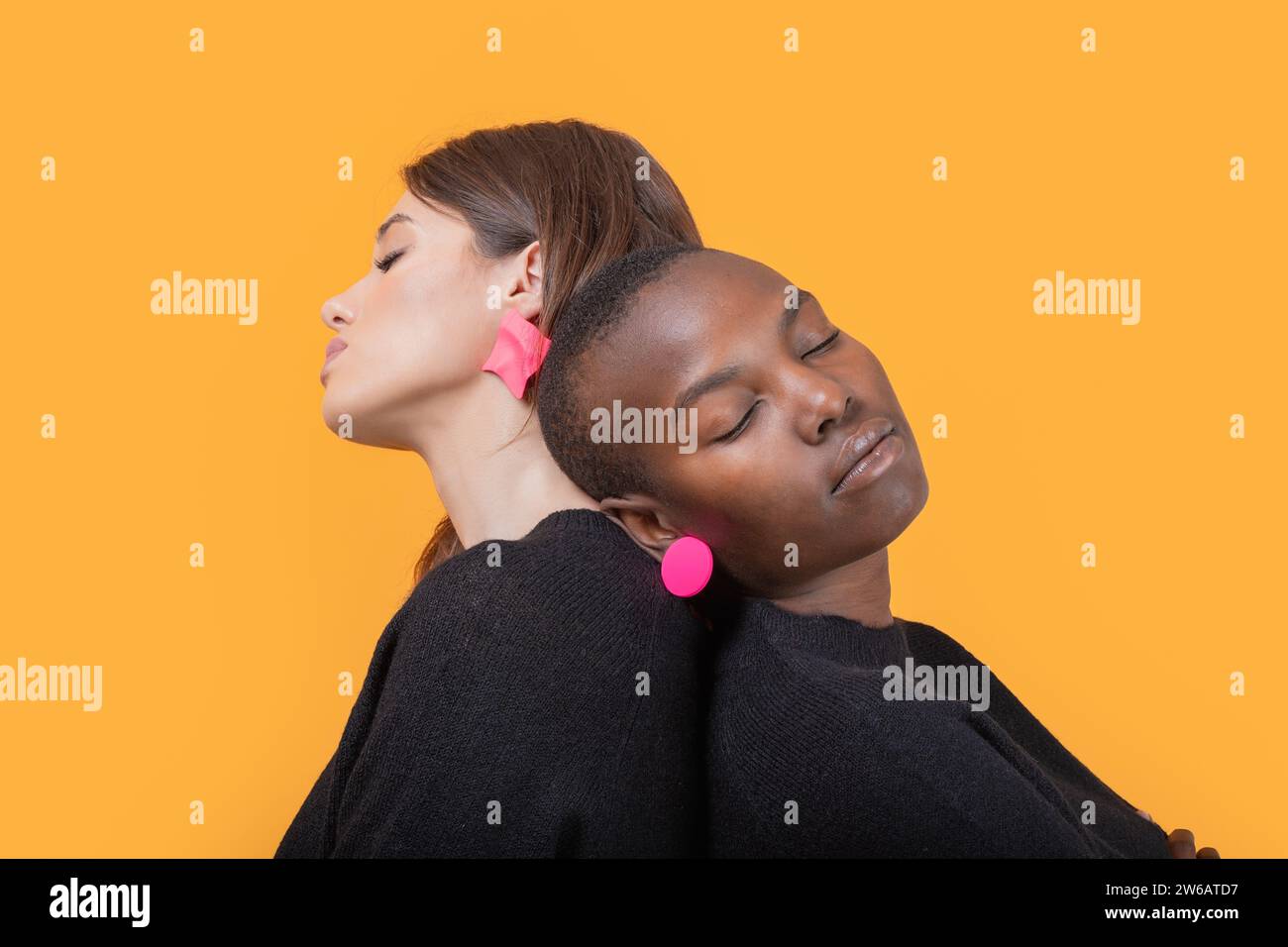 Side view of diverse young female friends leaning on each other with ...