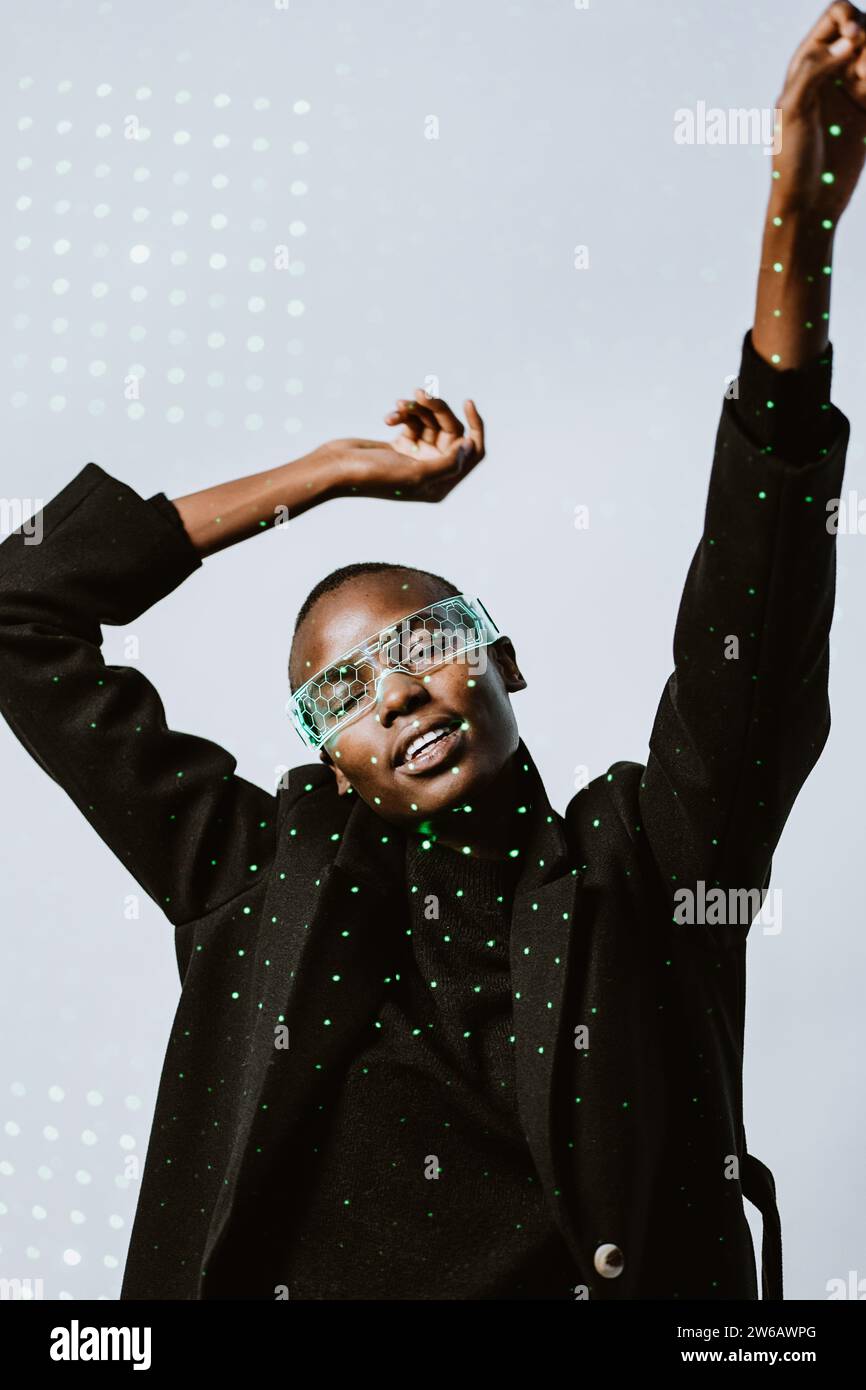 Cheerful young African American woman in illuminated smart goggles ...