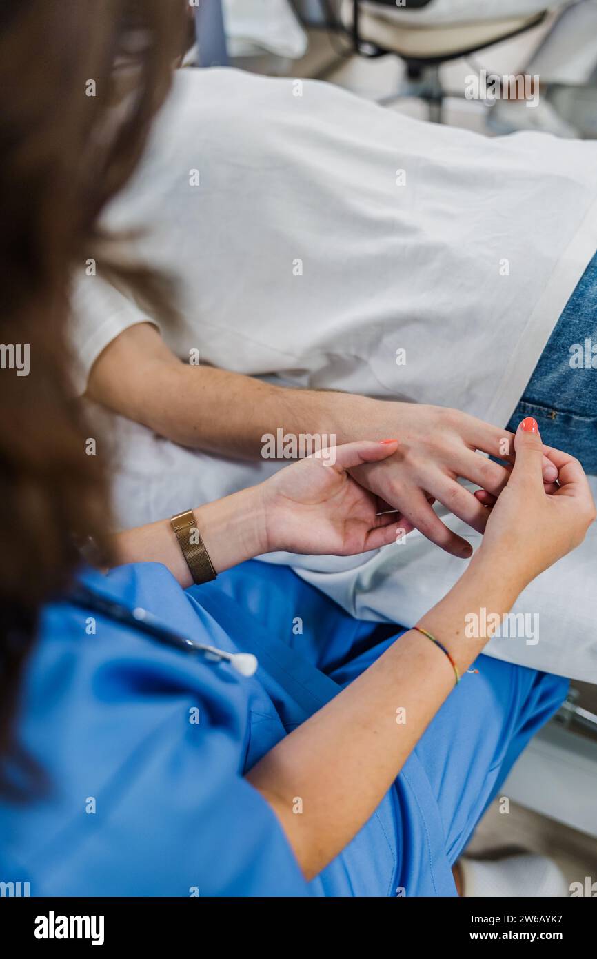 From below of anonymous female doctor in uniform while sitting near ...