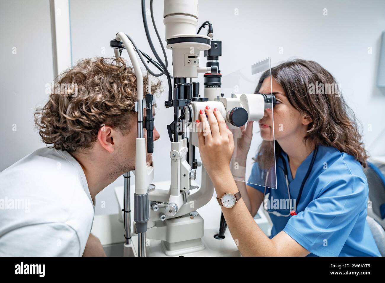 Side view of young female doctor in medical uniform and with ...