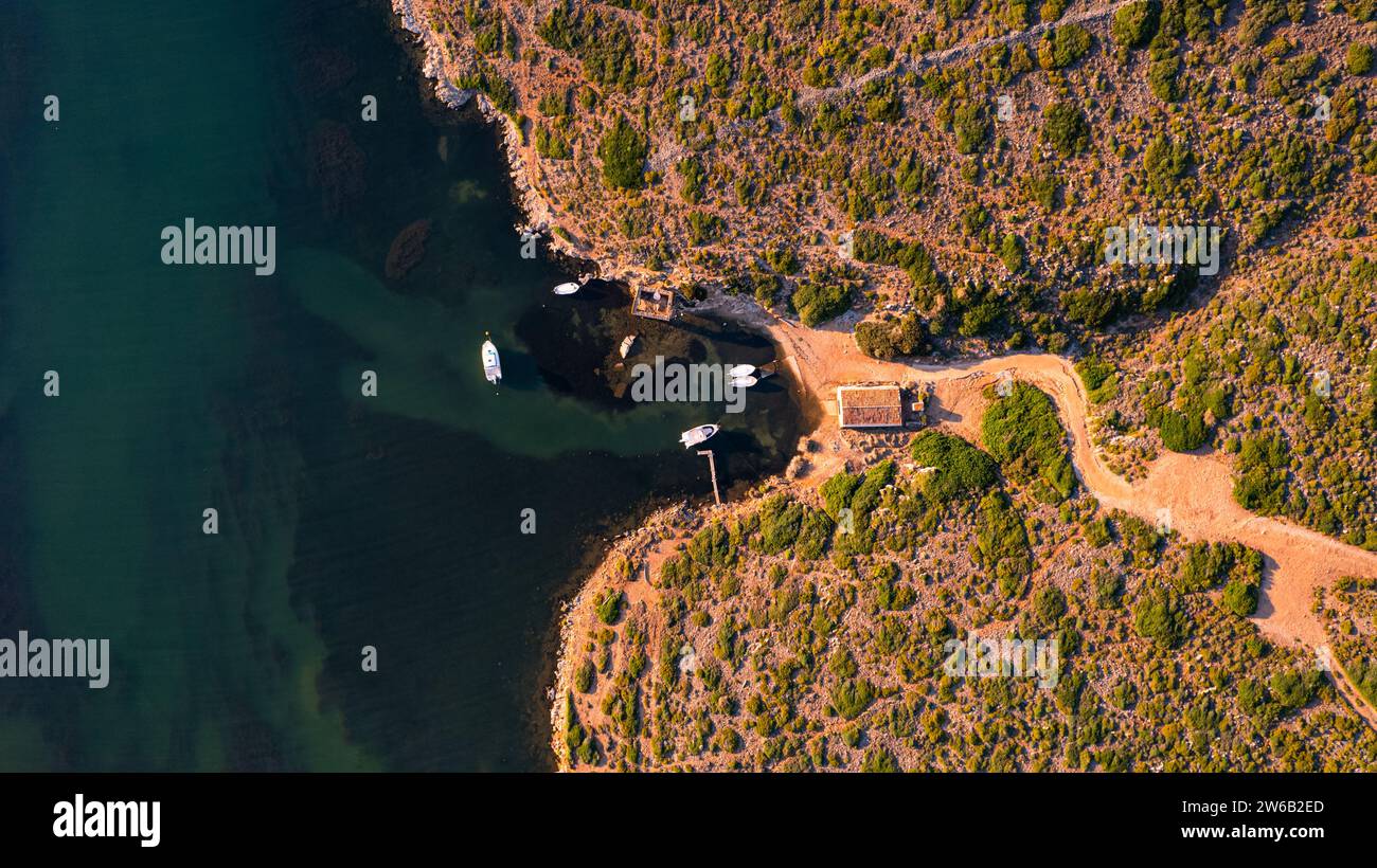 An overhead shot capturing the curves of a coastal road as it hugs the ...