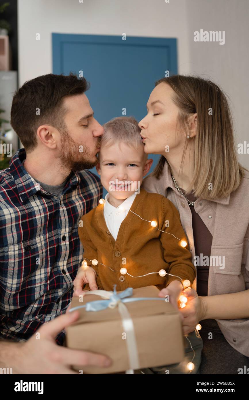 Young couple with closed eyes seated in front of a festive crop ...
