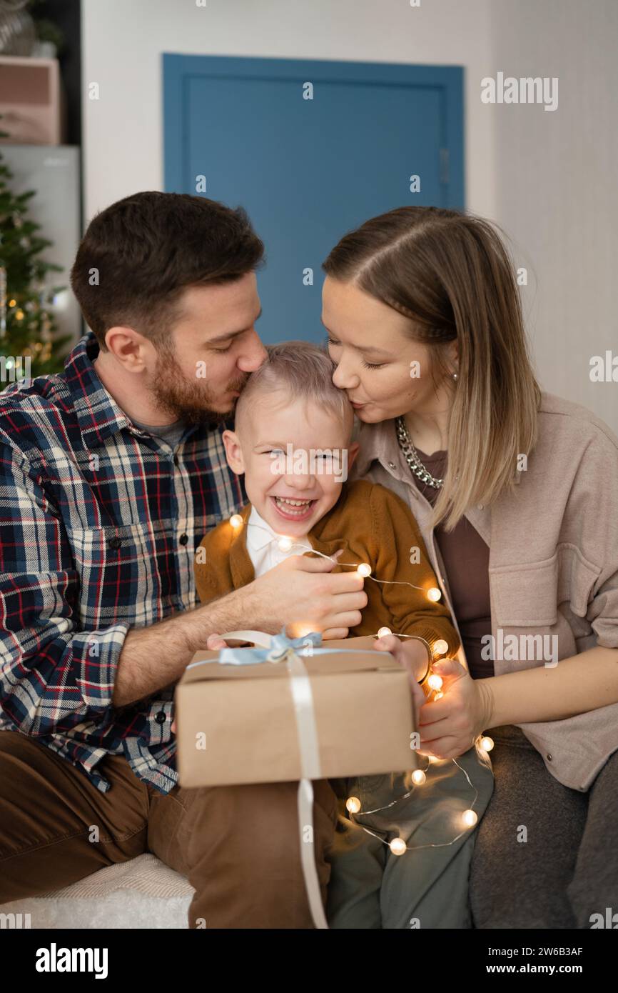 Young couple with closed eyes seated in front of a festive crop ...