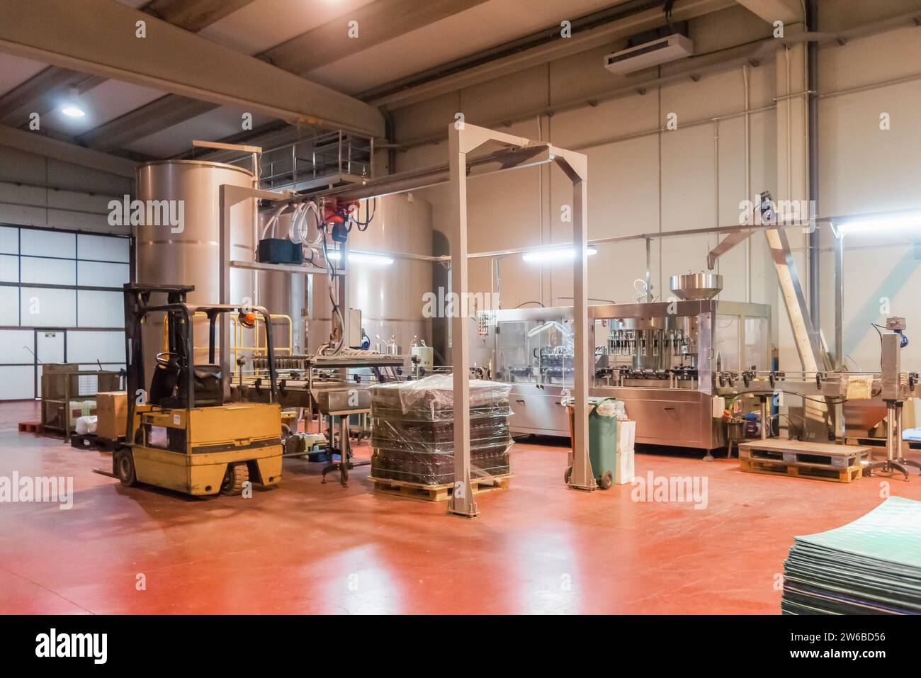 Interior of modern industrial factory with metal storage tanks and ...