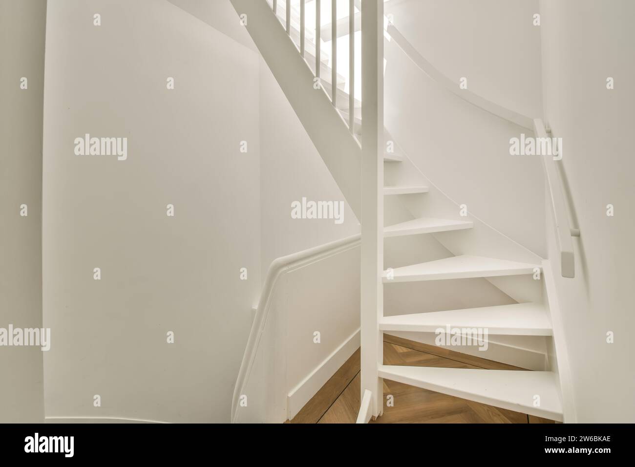 Empty white wooden staircase leading to loft in hallway with blank ...