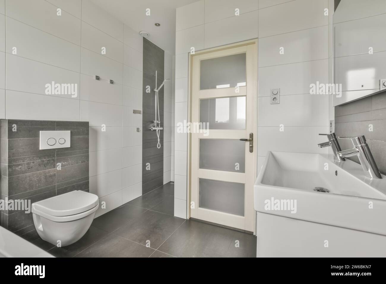 Sink and toilet seat in lavish bathroom of contemporary apartment with ...