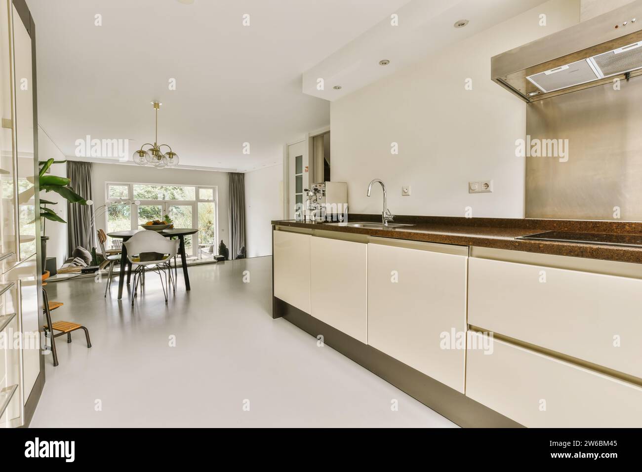 Bright and spacious modern kitchen with integrated dining area, large ...