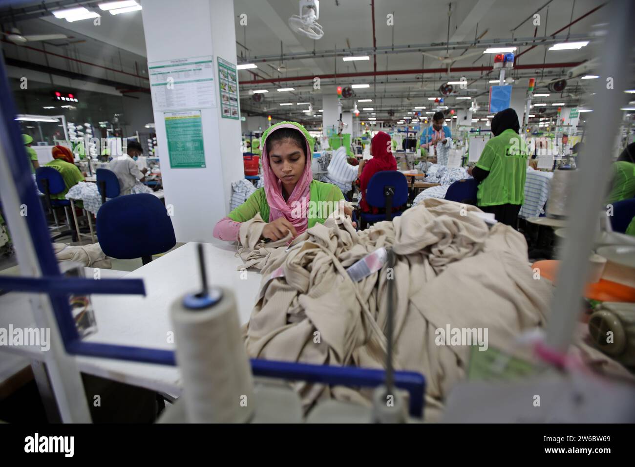 Ready-made garments worker works in a garments factory in Dhaka, Bangladesh on December 21, 2023 ...