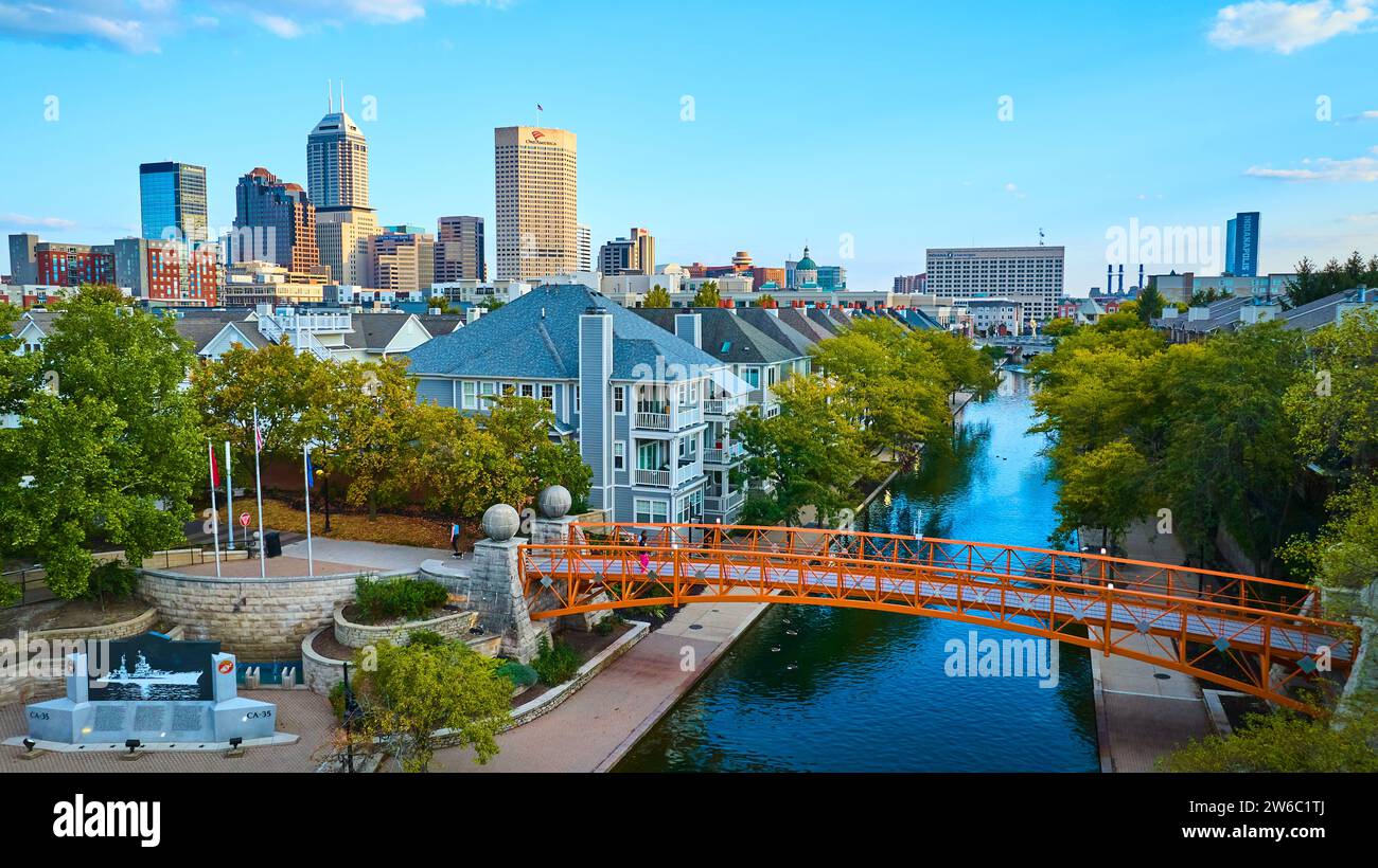 Aerial View of Urban Canal with Orange Bridge and City Skyline Stock ...