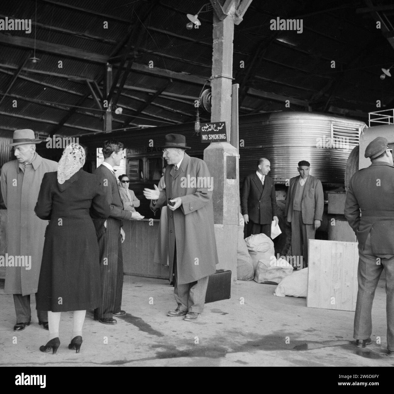 Passengers saying goodbye in a bus station,in the background the bus to ...