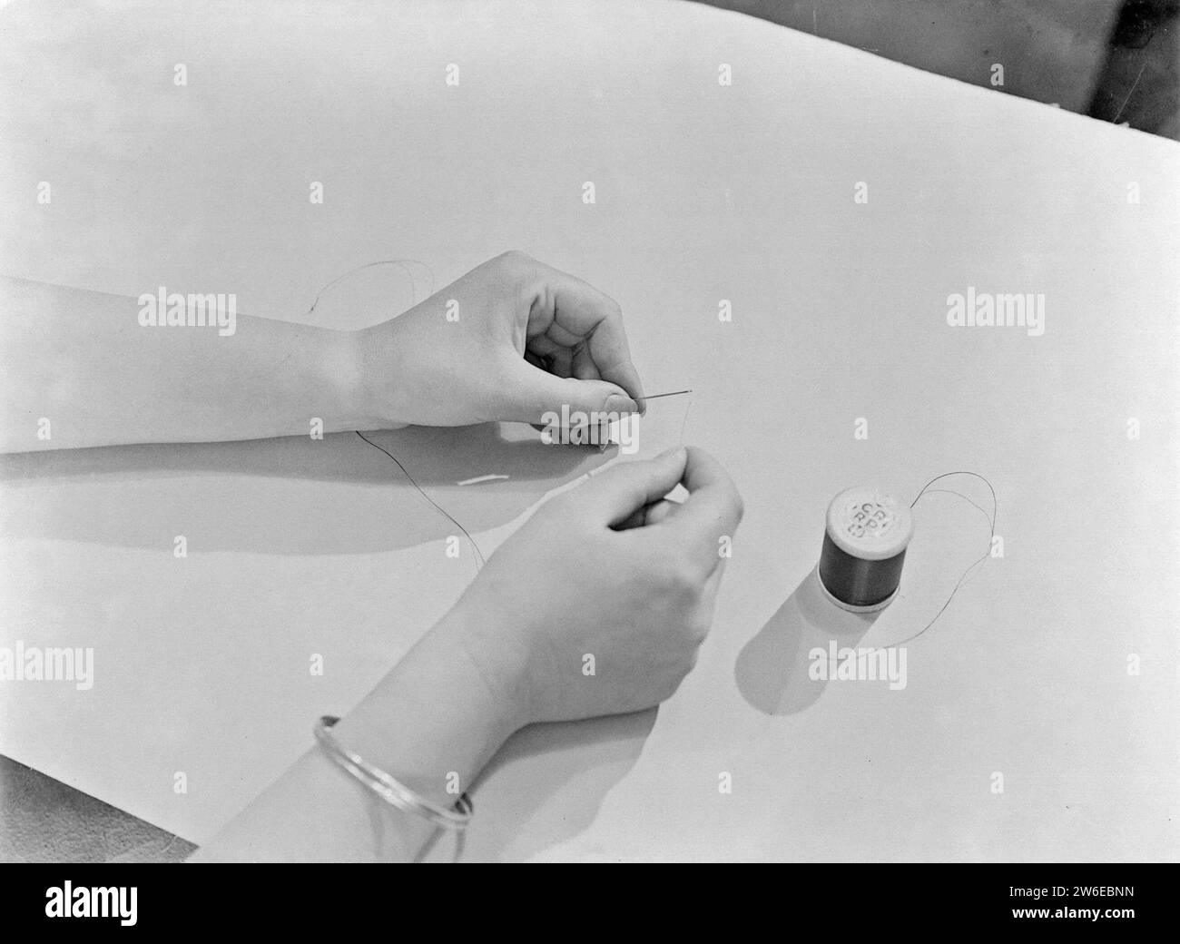 Hand threading Black and White Stock Photos & Images - Alamy