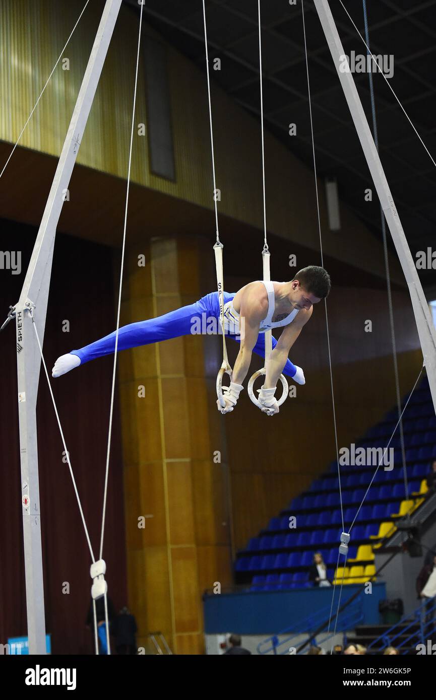 Male gymnast performing on stationary gymnastic rings Stock Photo - Alamy
