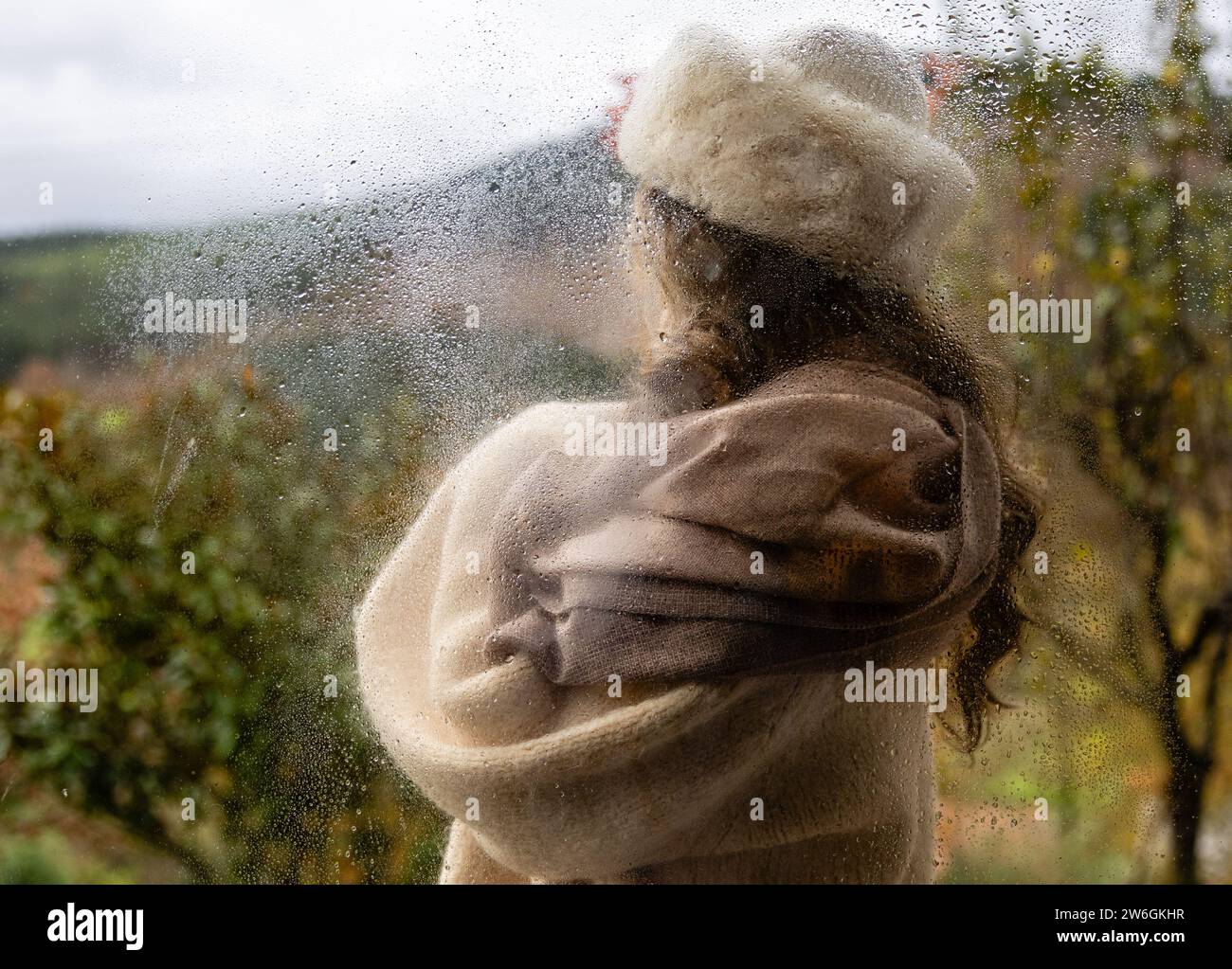 Portrait of a woman with shade and dressed in cold weather behind the ...
