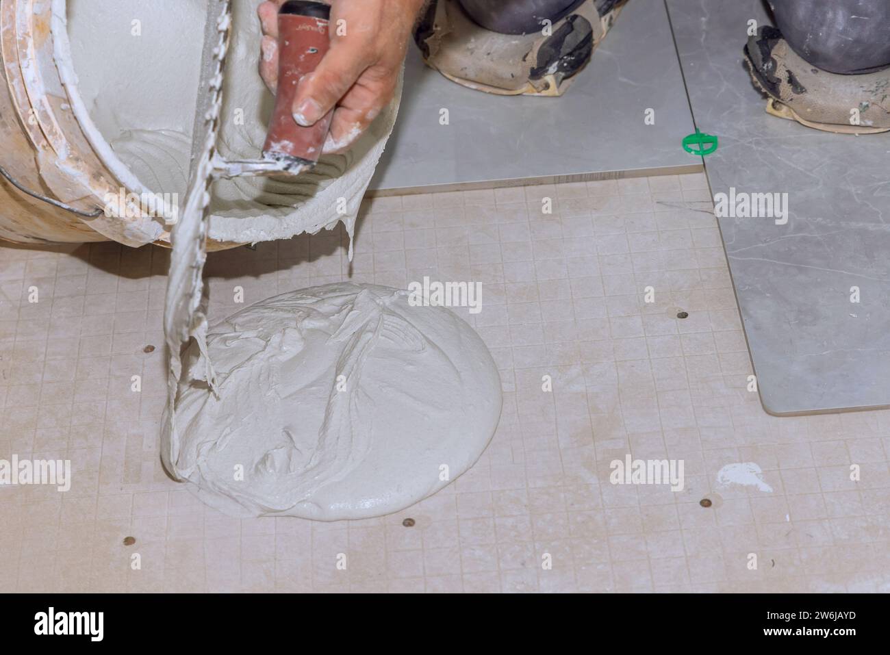 An adhesive mortar cement plaster surface is prepared for installation ...