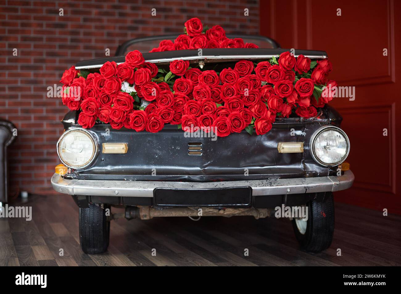Retro car with red flowers of roses for interior Stock Photo - Alamy