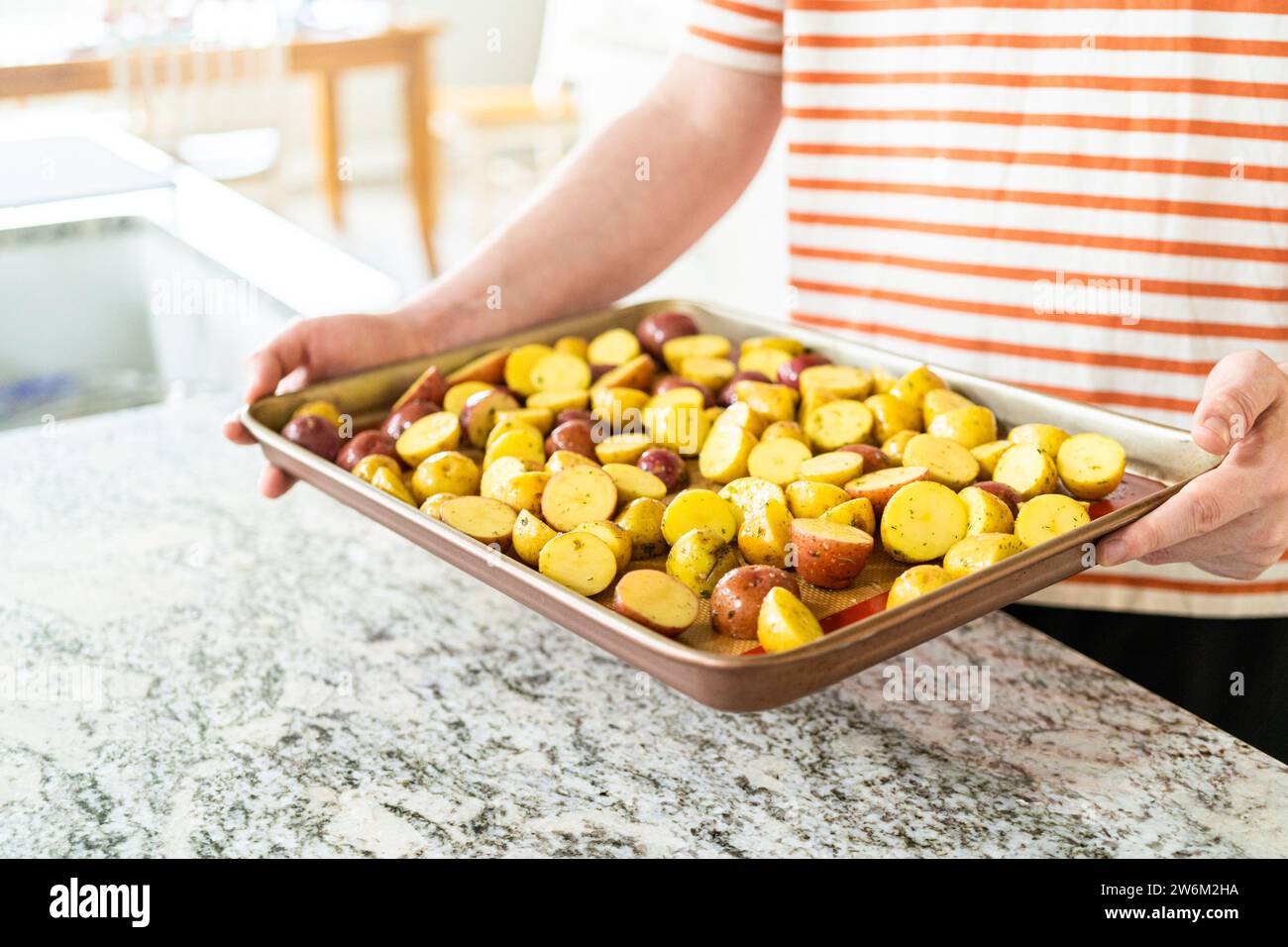 Roasting Halved Mixed Marble Potatoes in Modern Kitchen Stock Photo - Alamy