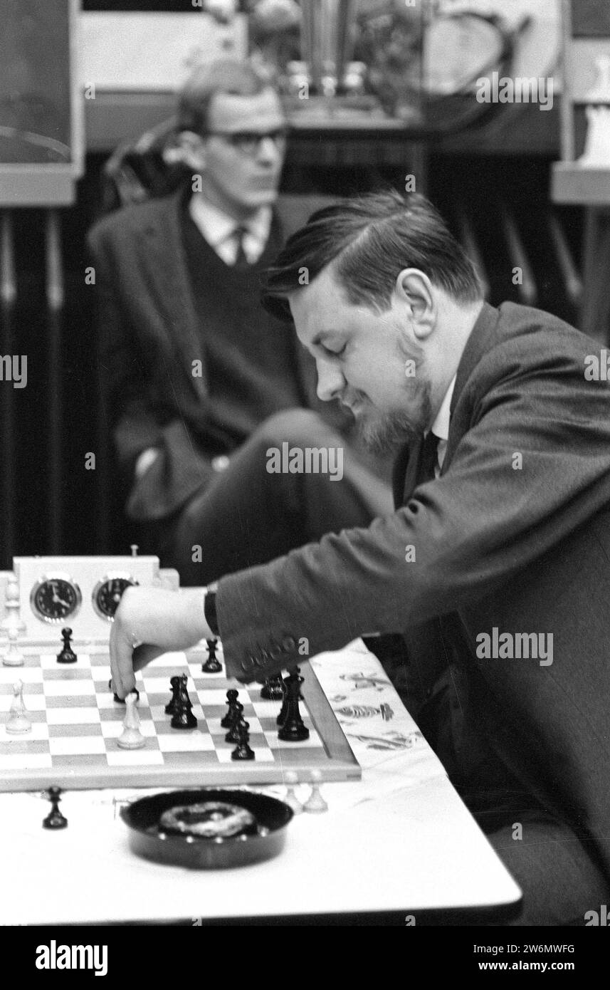 Blast furnace chess tournament. Chess player moving a chess piece ca ...