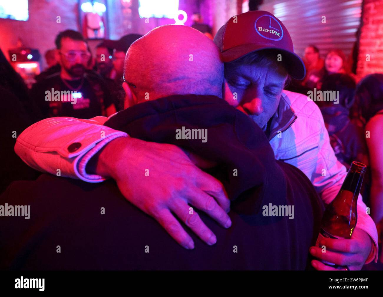James Pence, co-owner, back, hugs Anthony Gonzalez, front, on Tuesday ...