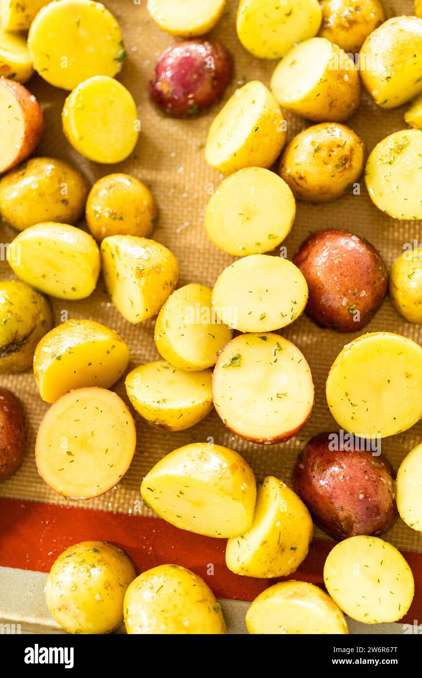 Roasting Halved Mixed Marble Potatoes in Modern Kitchen Stock Photo - Alamy