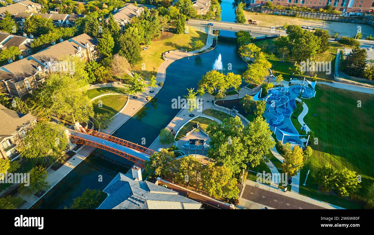 Aerial View of Suburban Park with Waterway and Playground at Sunset ...