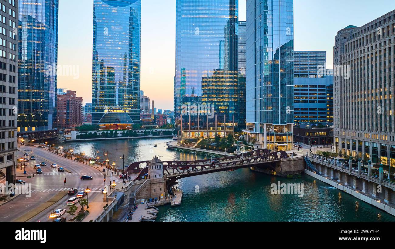 Chicago canal bridge aerial with city lights and skyscrapers at blue ...