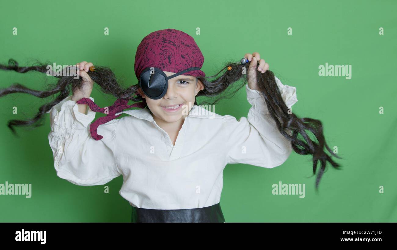 Adorable kid pirate with long hair and eye patch pissing with angry ...