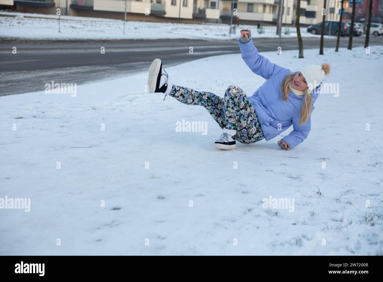 The girl slipped on an icy sidewalk in the city Stock Photo - Alamy
