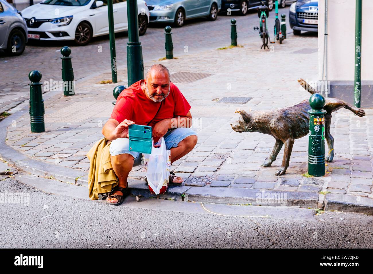 Tourist photographing the Zinneke Pis dog statue. Het Zinneke ...
