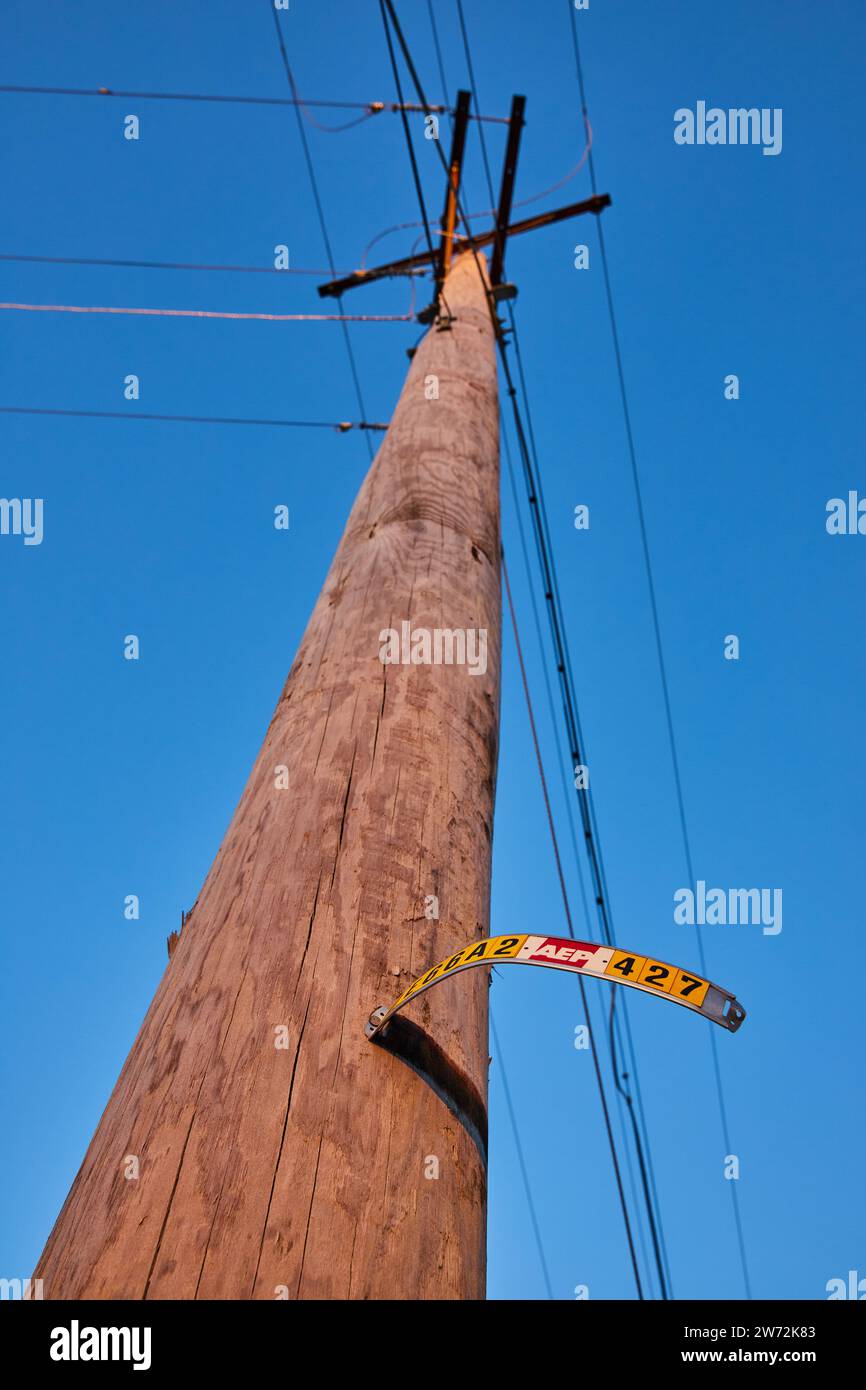 Weathered Utility Pole with Bent Street Sign, Blue Sky Background Stock ...
