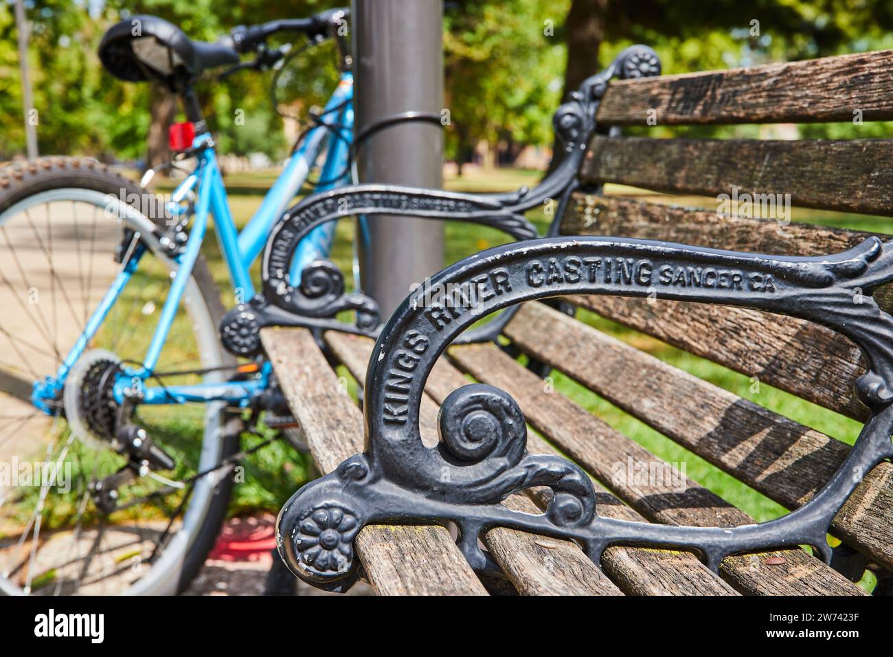 Ornate Park Bench and Bicycle in Urban Green Space Close-Up Stock Photo ...