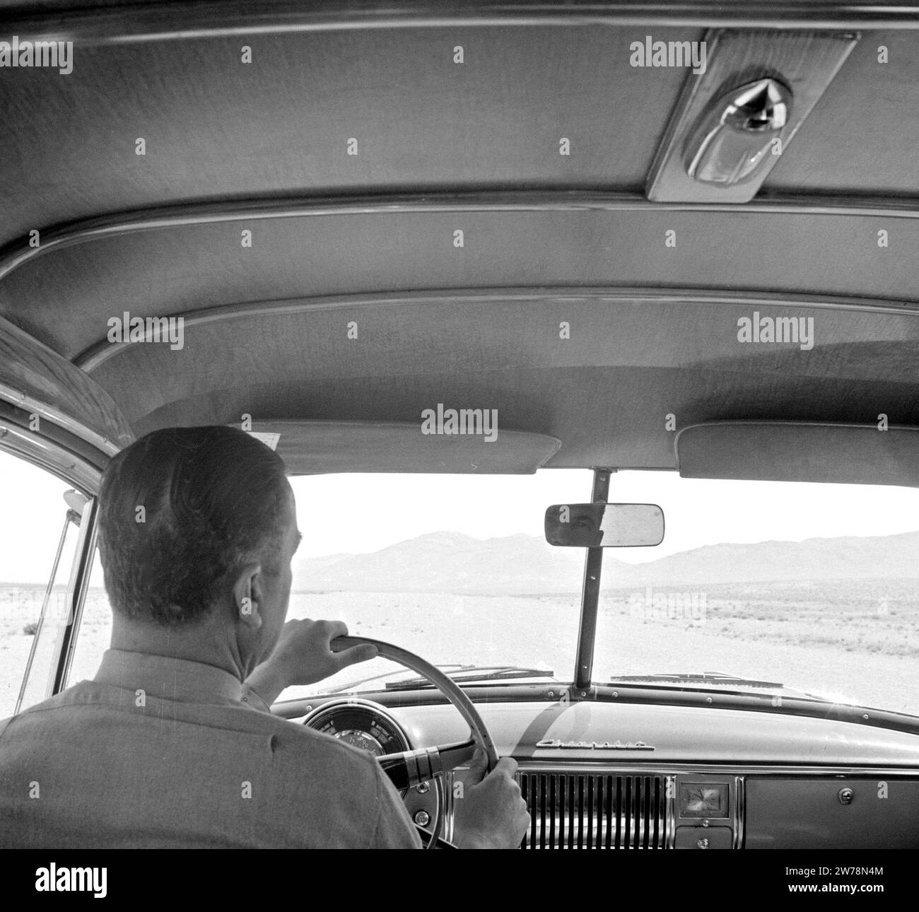 Man driving a car in the desert on the road from Malula to Damascus ca ...