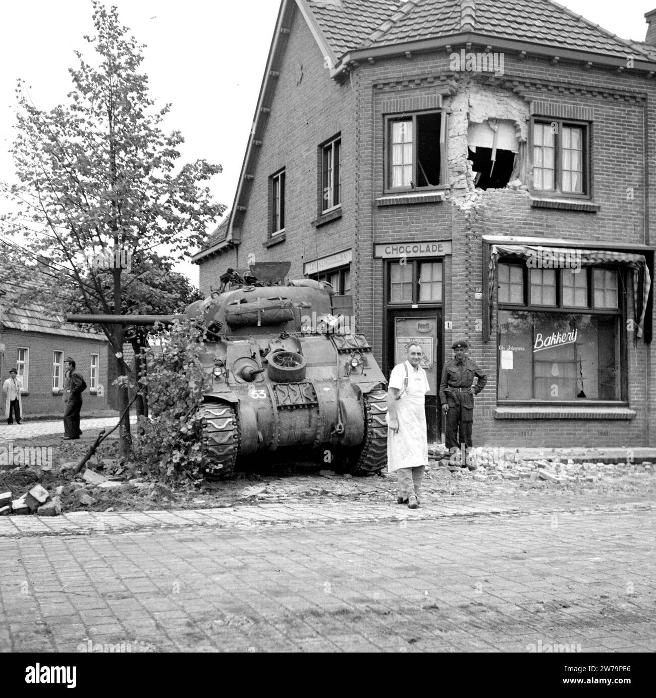 Resident of Aalst posing in front of an Irish Guards tank at a badly ...