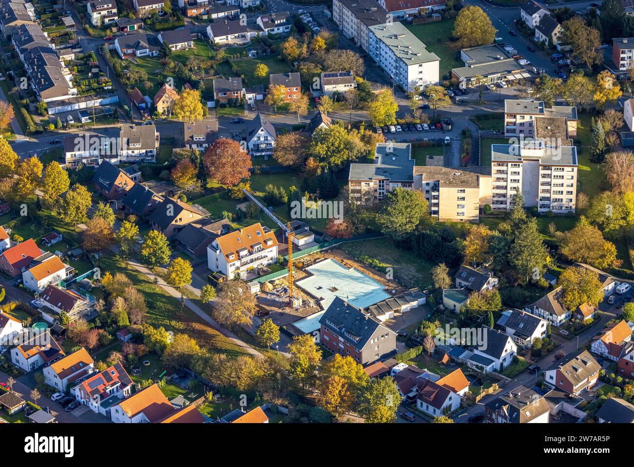 Aerial view, construction site and construction crane with new building in the residential area ...