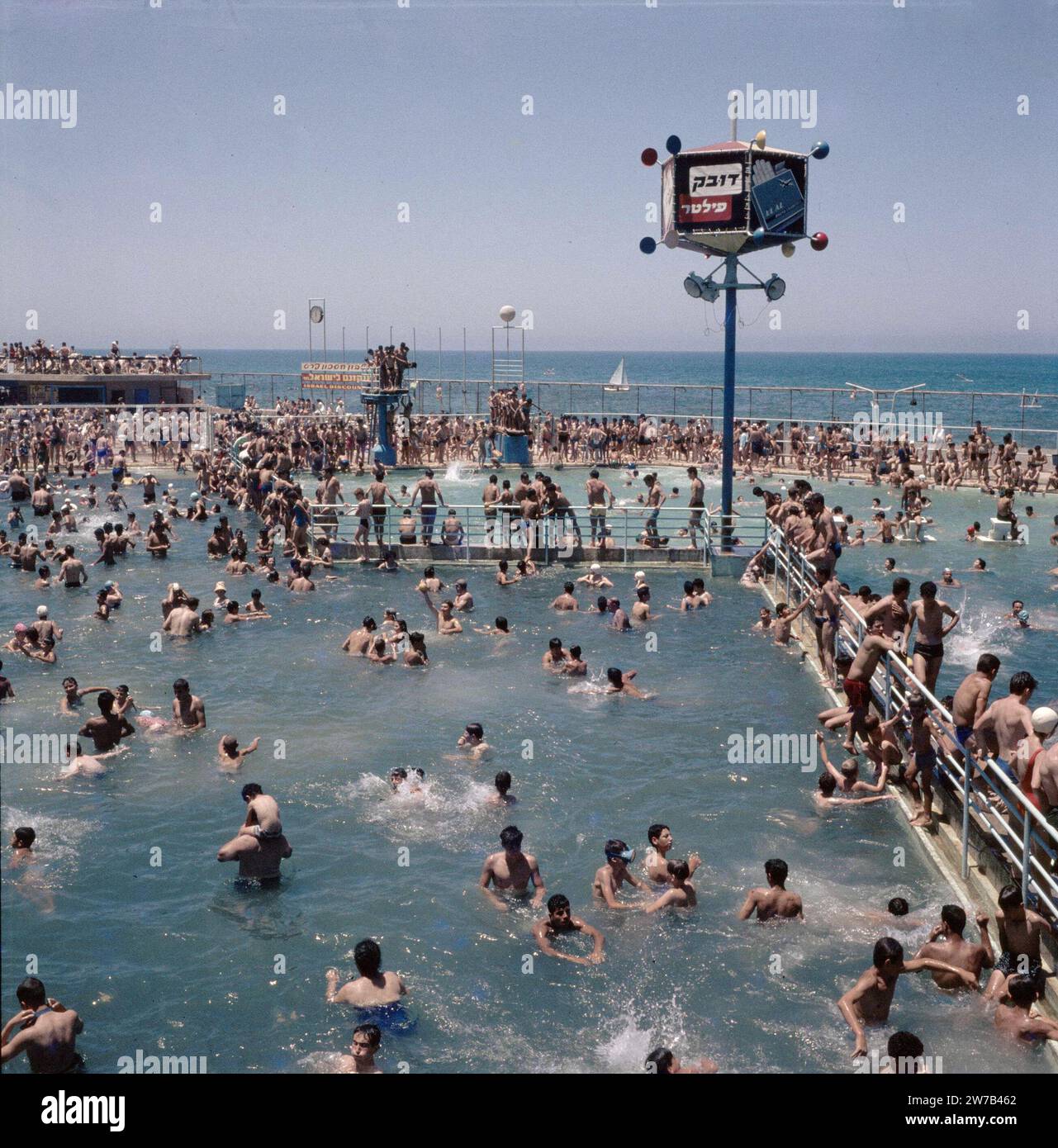 Tel Aviv. The overcrowded open-air pool on the boulevard, containing a ...