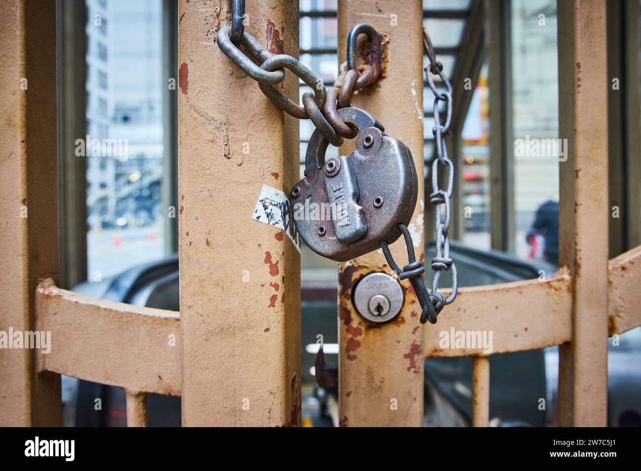 Thick lock on iron fence with chains in industrial zone on gloomy day ...