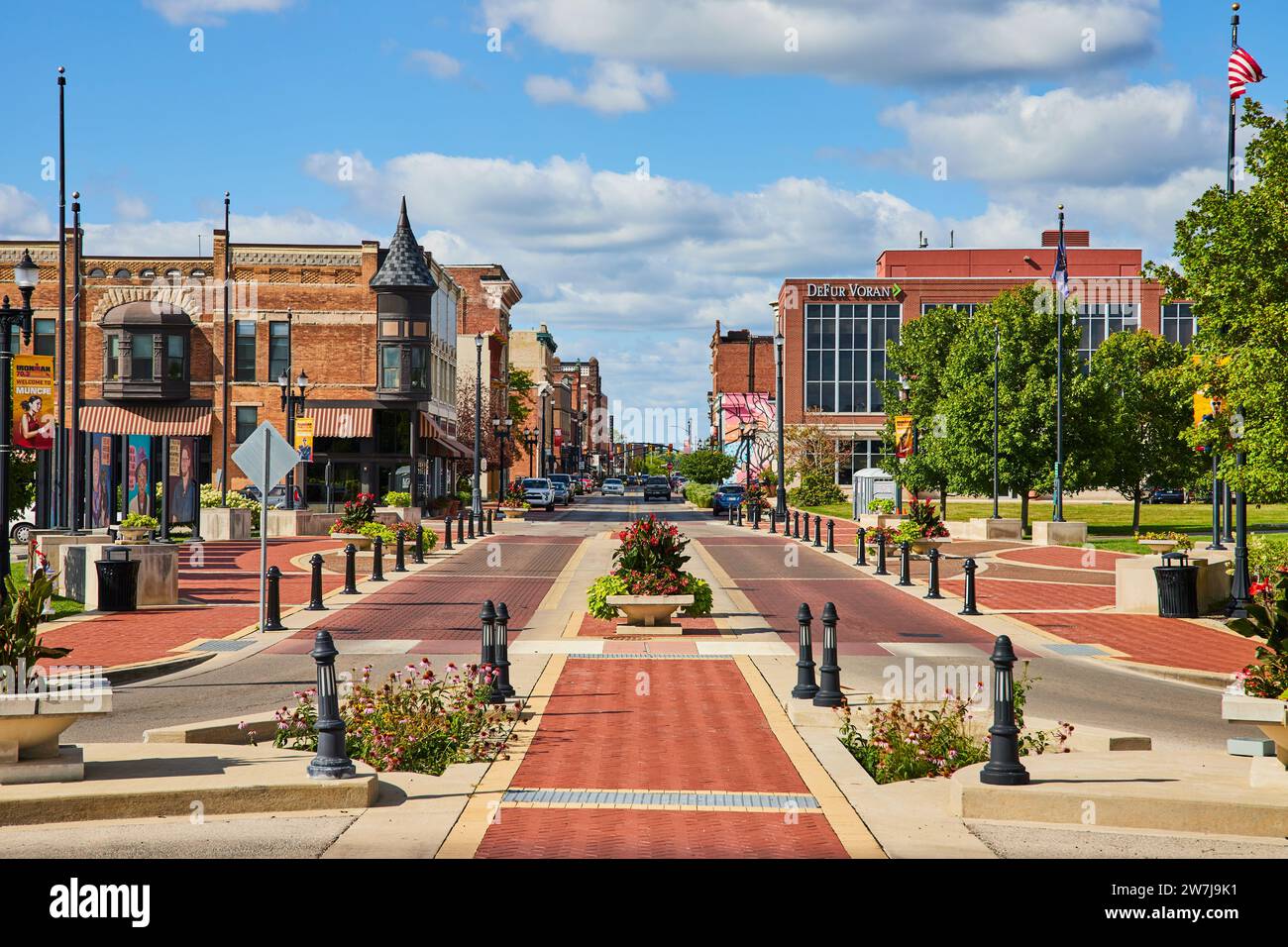 Sunny American Main Street with Brick Buildings and Flowers Stock Photo ...