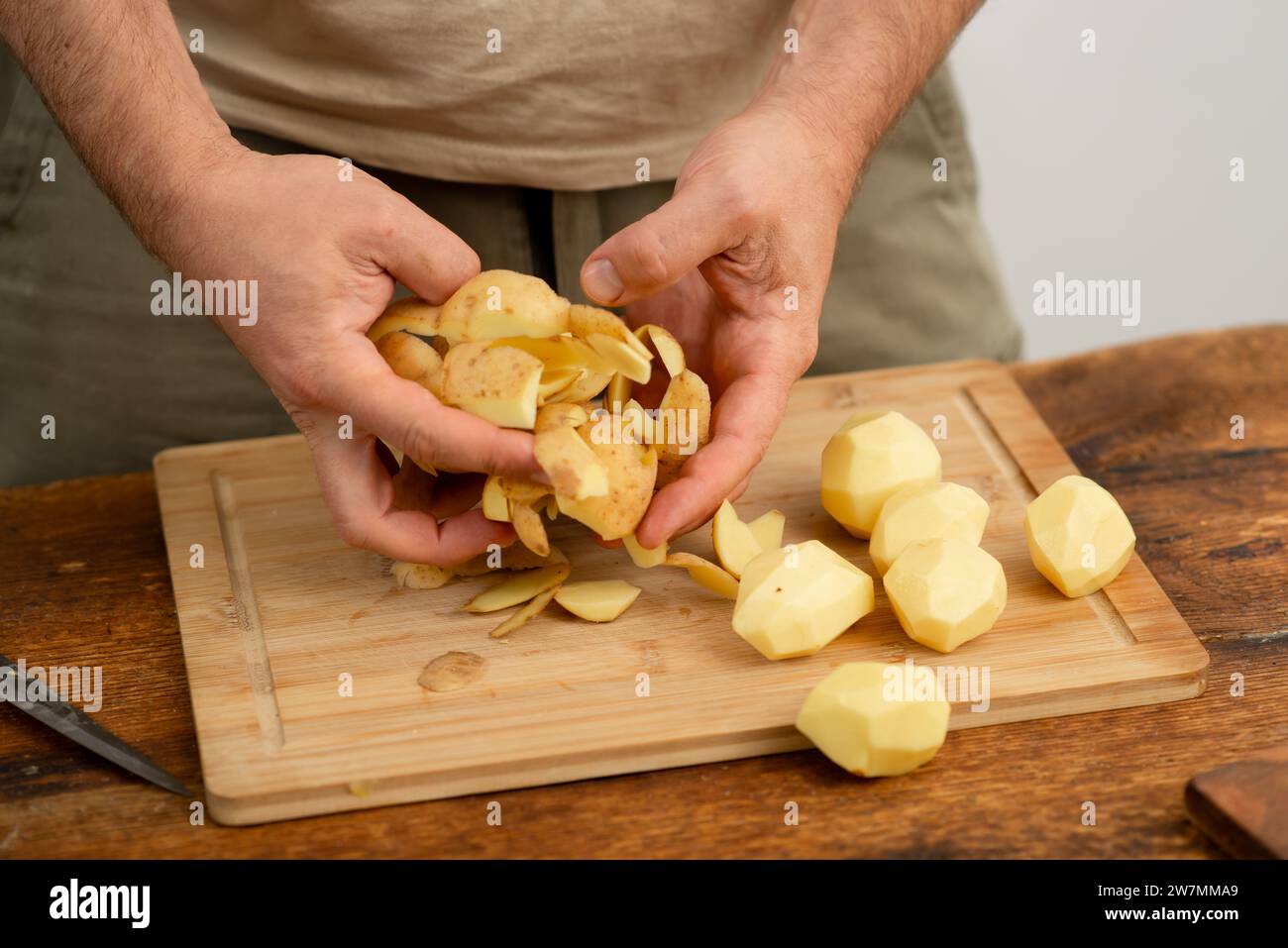 Peeling potatoes for dinner, a simple culinary technique Stock Photo ...