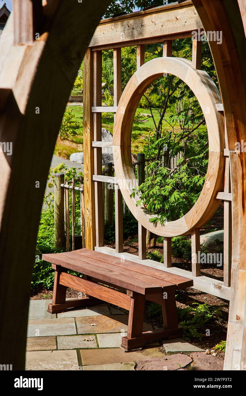 Serene Garden with Wooden Bench and Circular Gate, Eye-Level View Stock ...