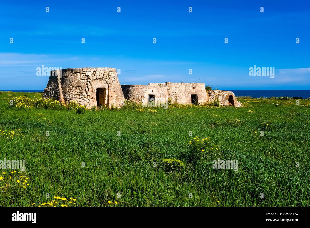 Ruins of some old trulli, the traditional Apulian dry stone hut with a ...