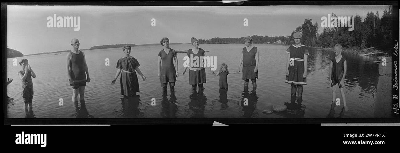 Wisconsin camp, people standing in a line in the water in bathing suits ...