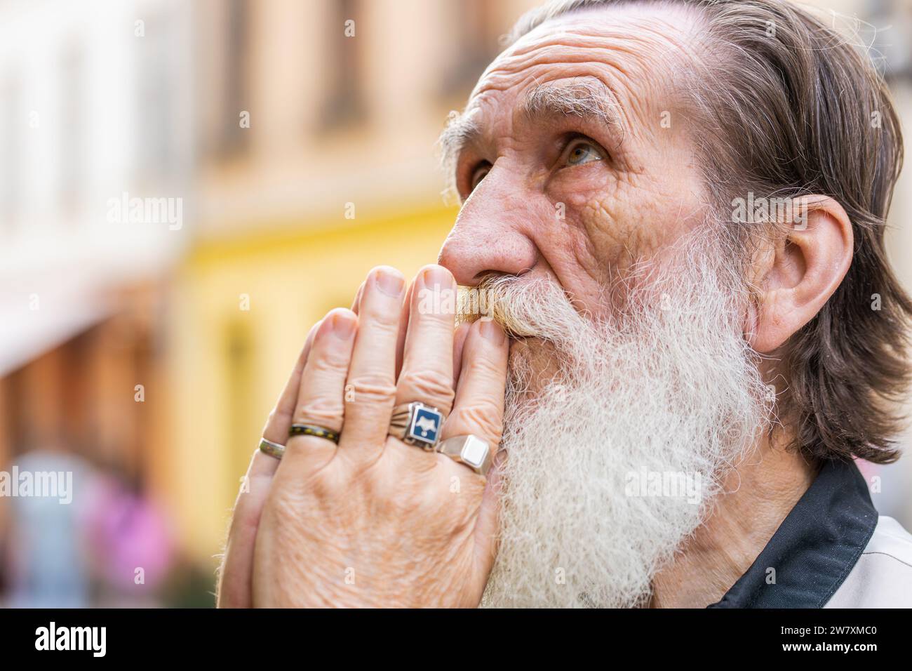 Portrait of bearded religion senior man praying with closed eyes to God ...