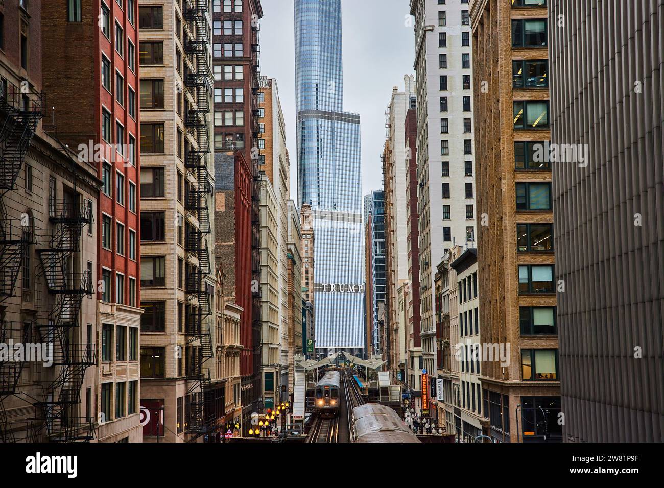 Elevated Train in Urban Canyon Amid Architectural Diversity Stock Photo ...