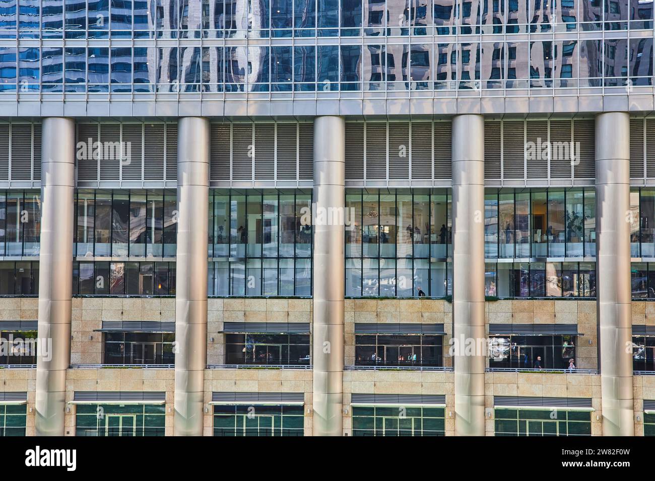 Chrome pillars with reflective windows and bars between in architecture ...