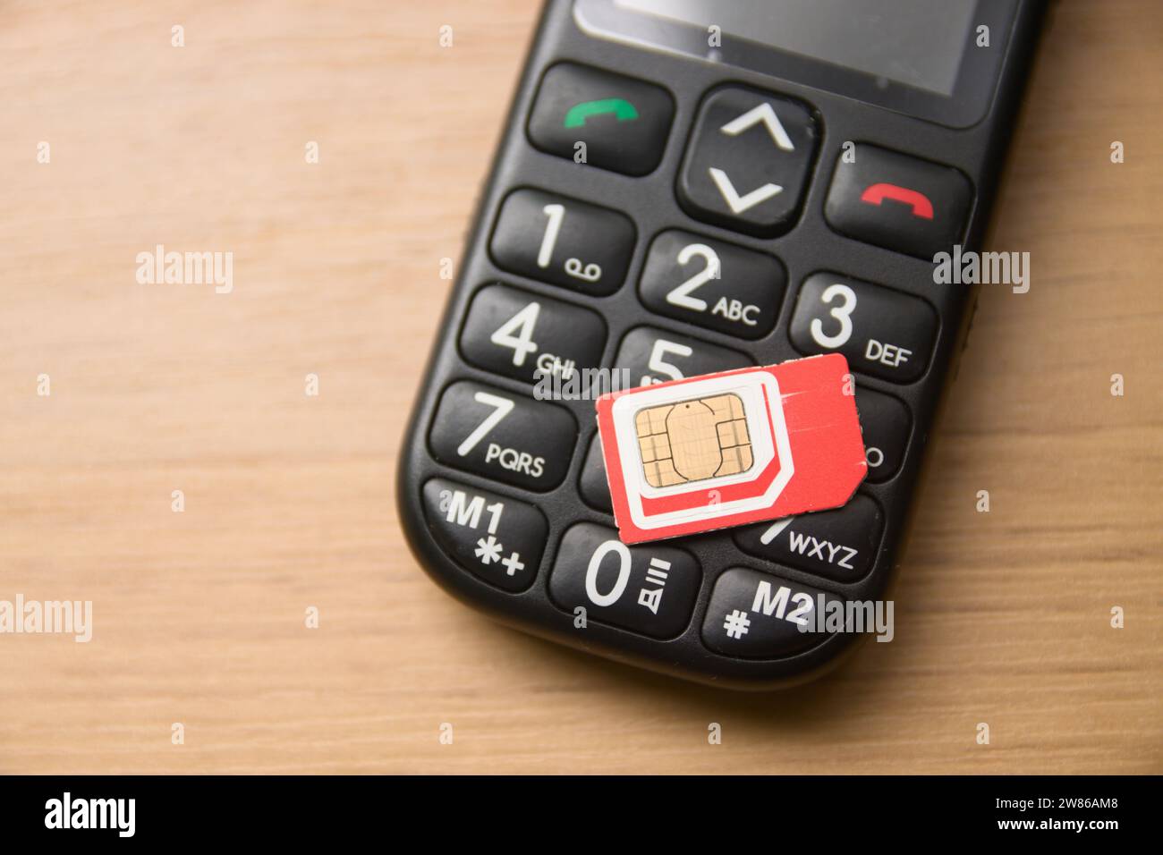 Closeup of an old mobile phone with large keys for elderly users who do ...