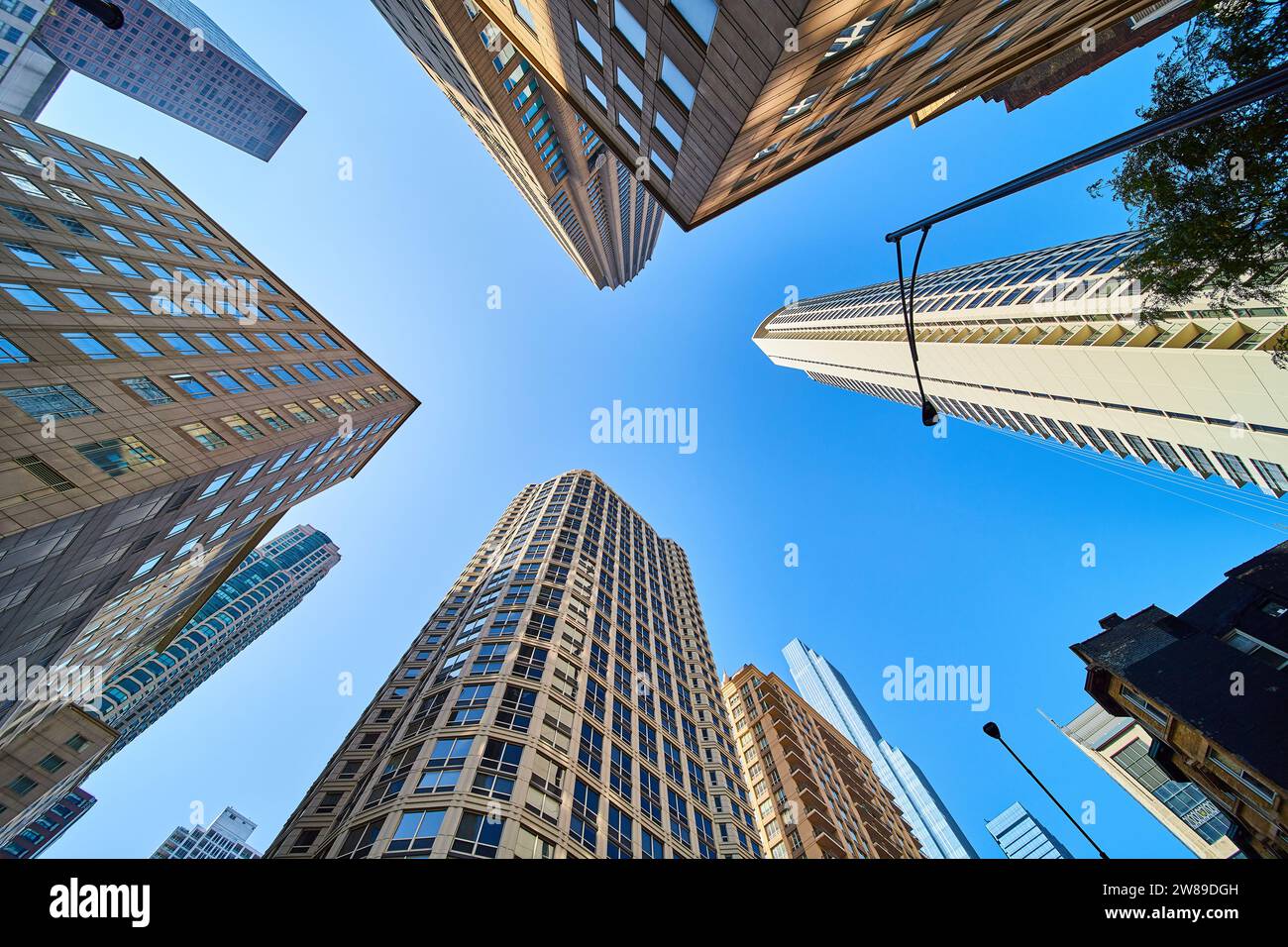 Upward view of Chicago skyscrapers stretching toward clear blue sky ...