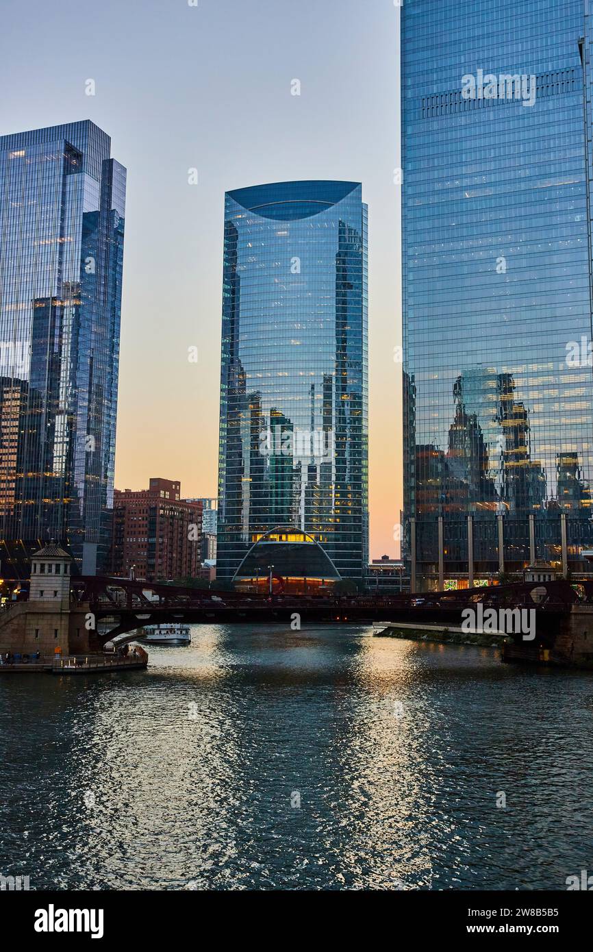 Chicago canal at dawn with light reflecting blue off skyscraper windows ...