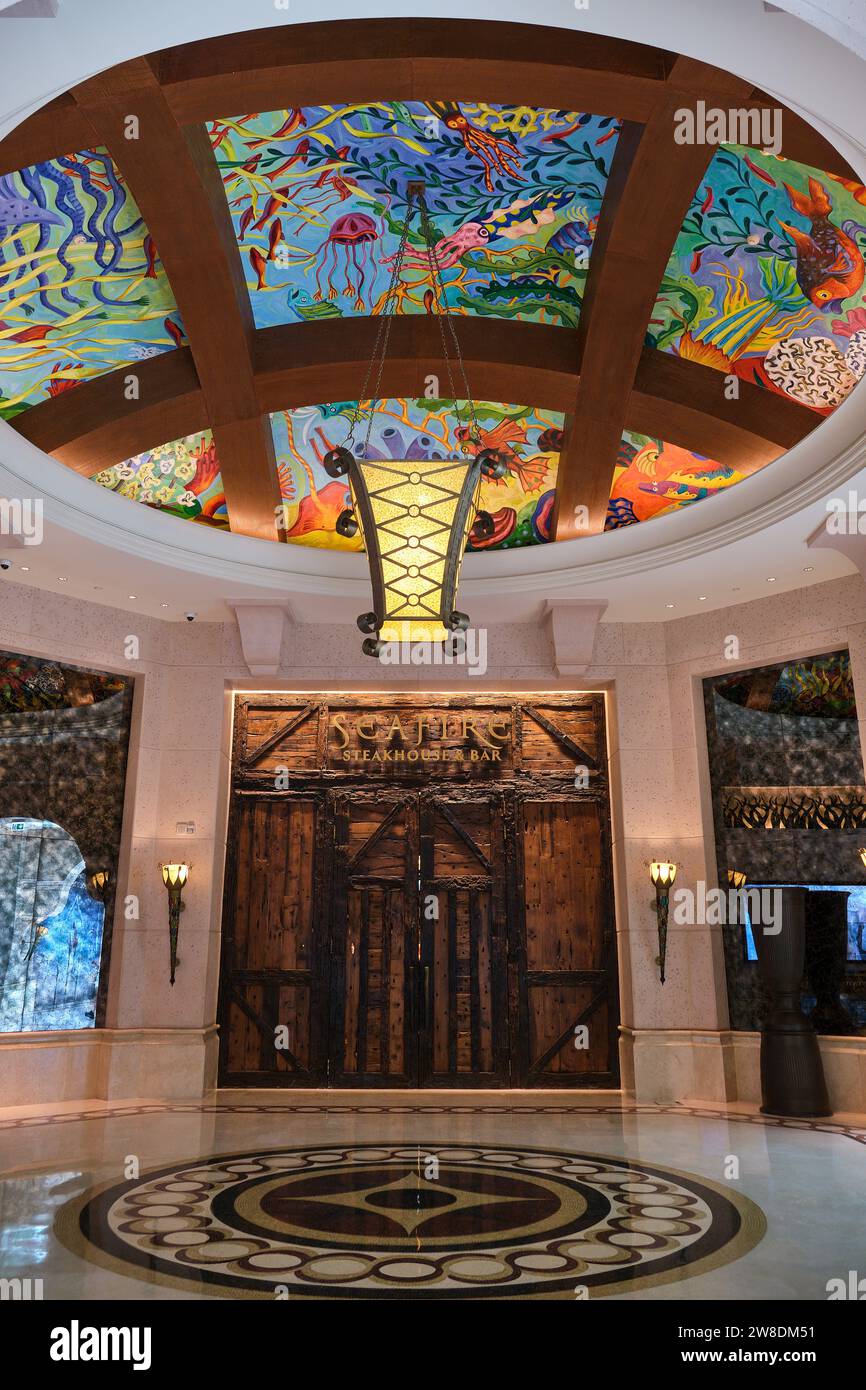 The elaborate wooden door of Seafire Steakhouse and sea creatures wall ...
