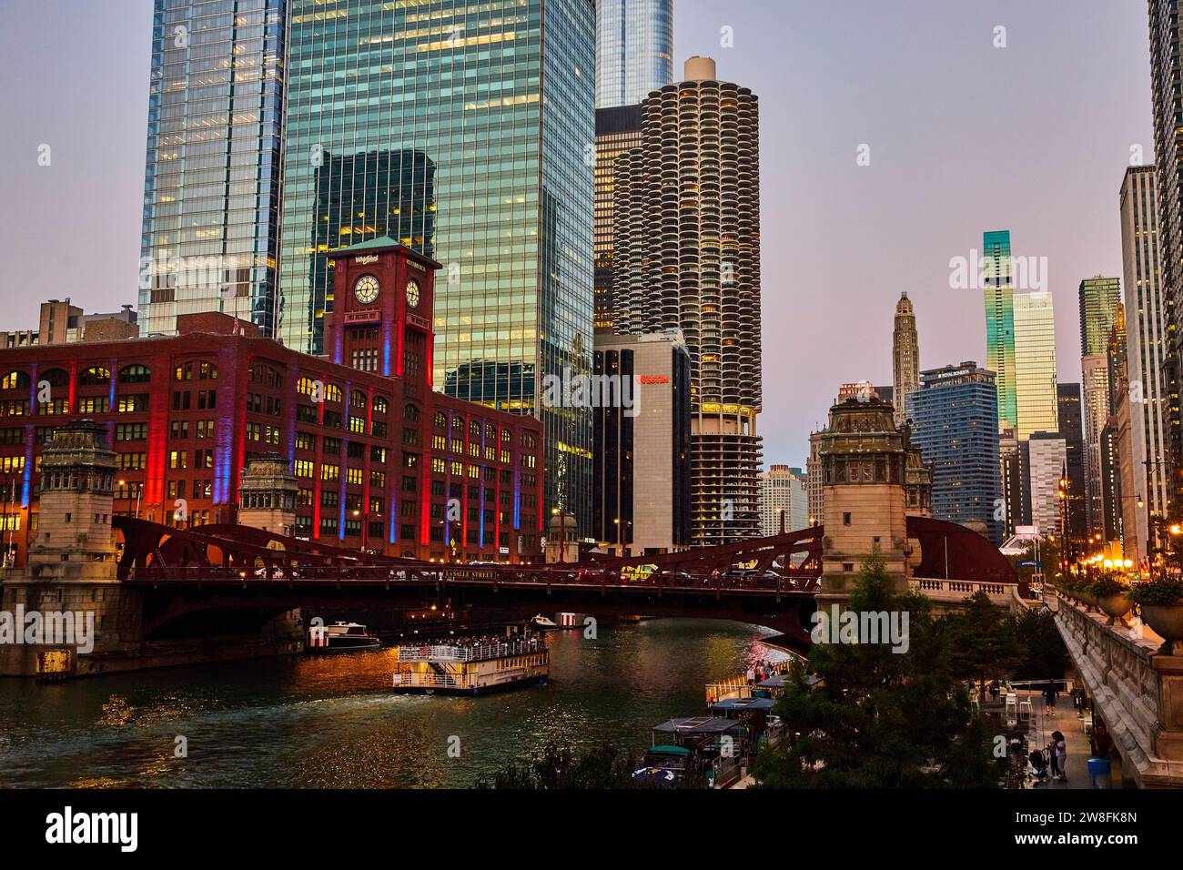 Gorgeous red and blue lights on red brick building along canal with ...