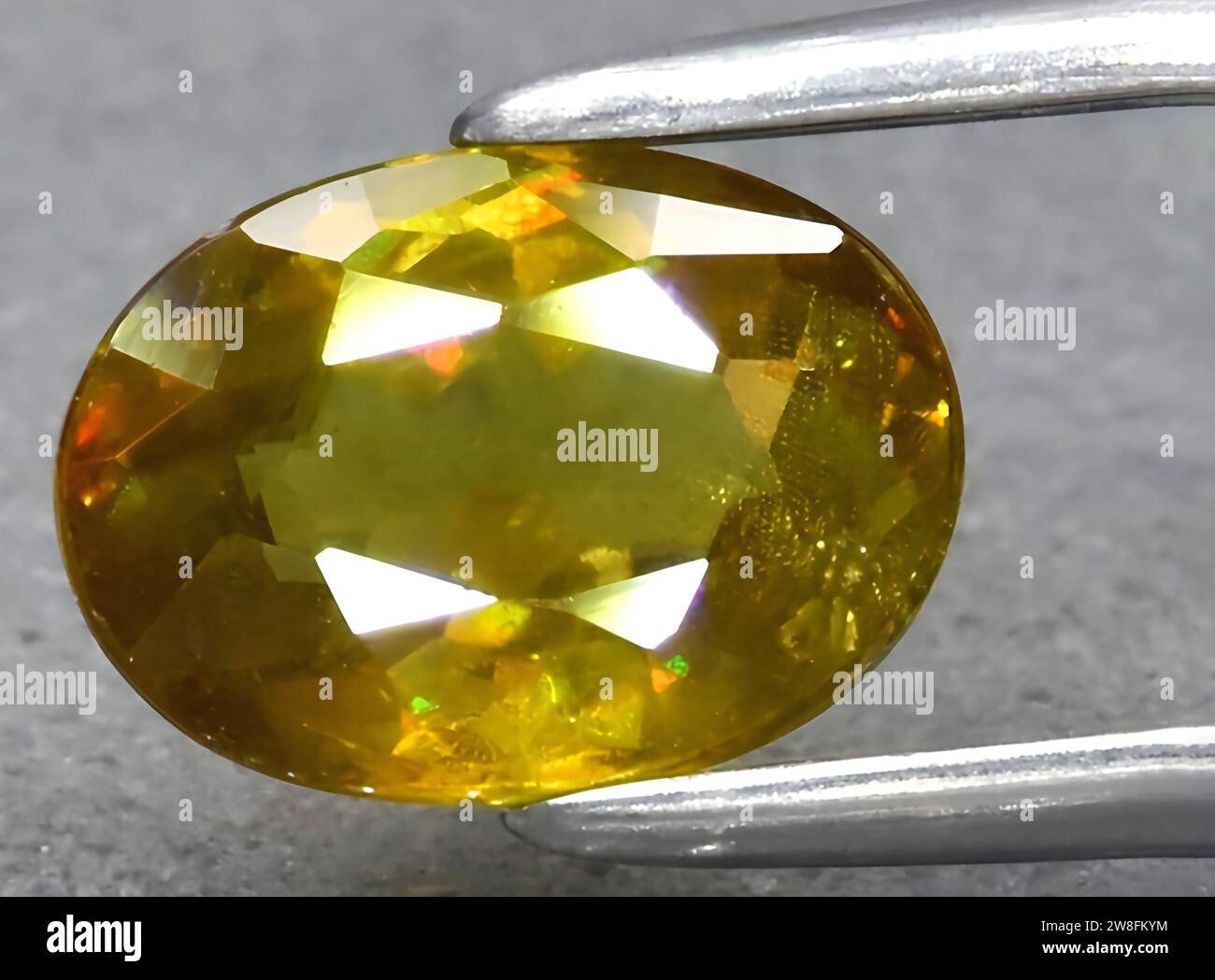 natural yellow sphene titanite gem on background Stock Photo - Alamy